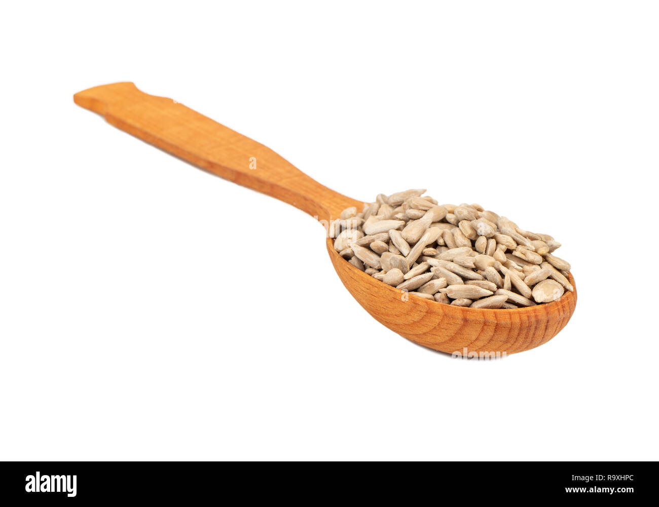 Sunflower seeds without shell in spoon closeup on white background ...