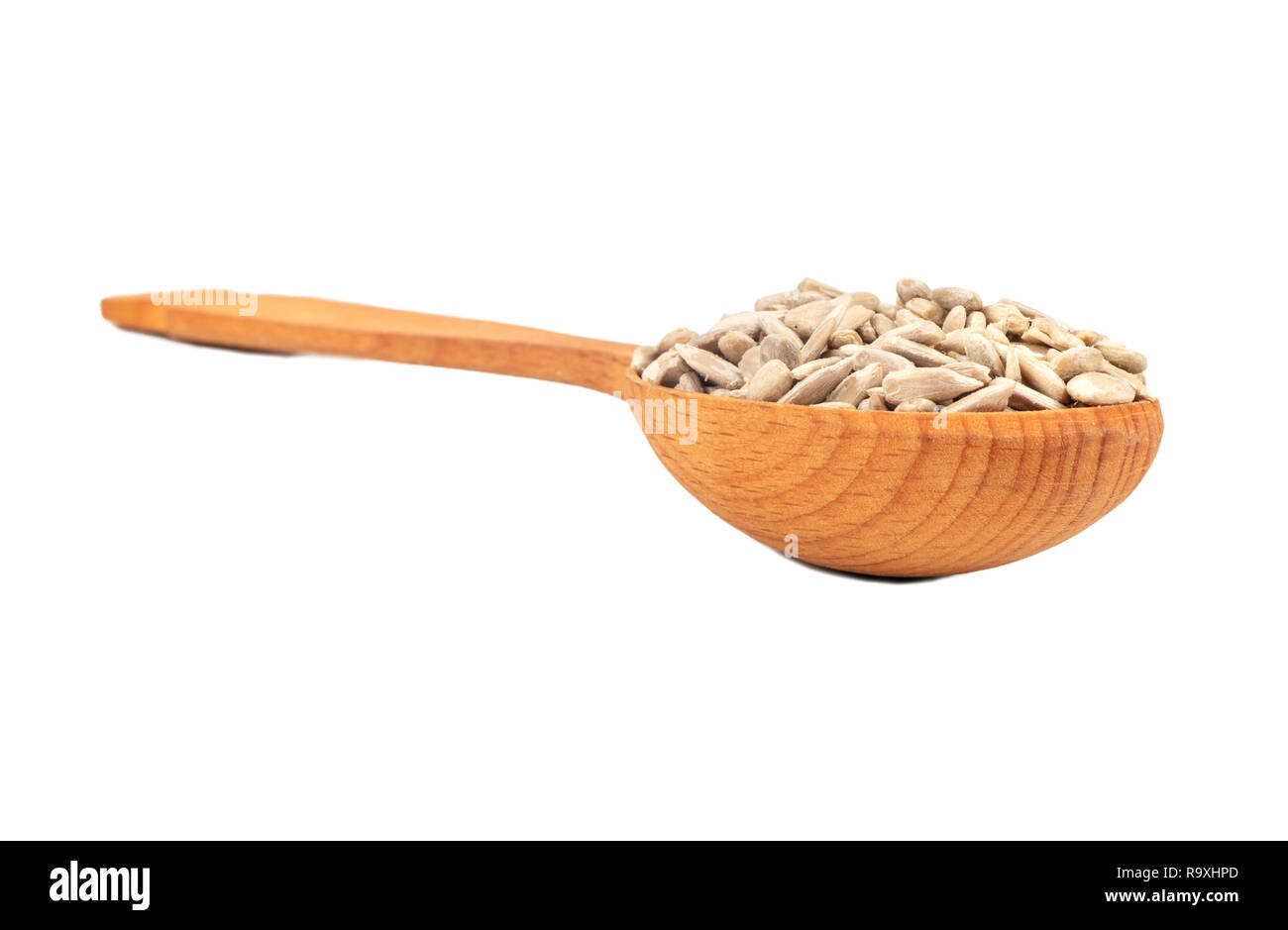 Sunflower seeds without shell in spoon closeup on white background ...