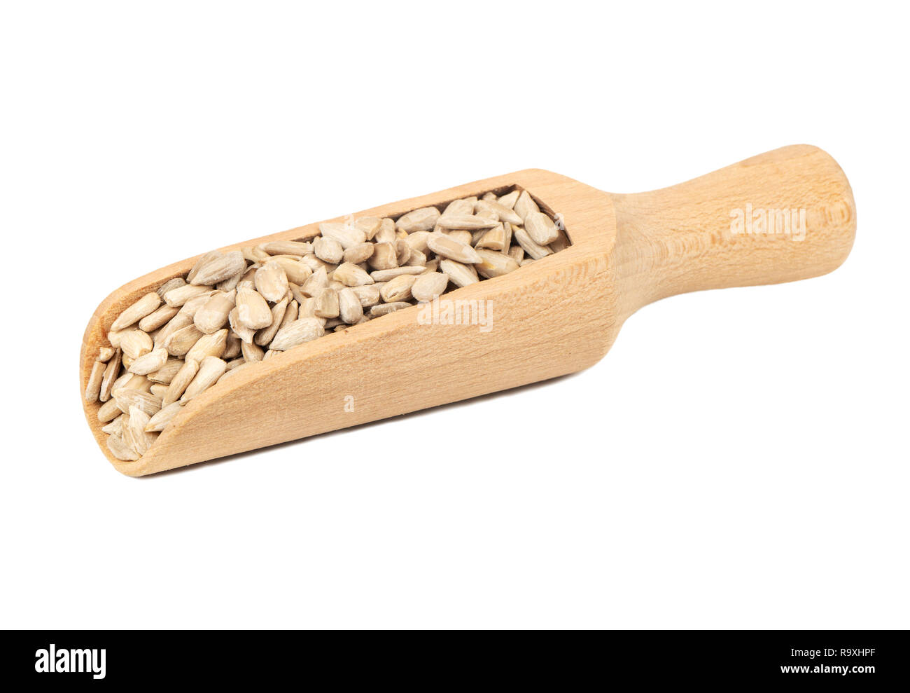 Sunflower seeds without shell in a wooden scoop on a white background ...