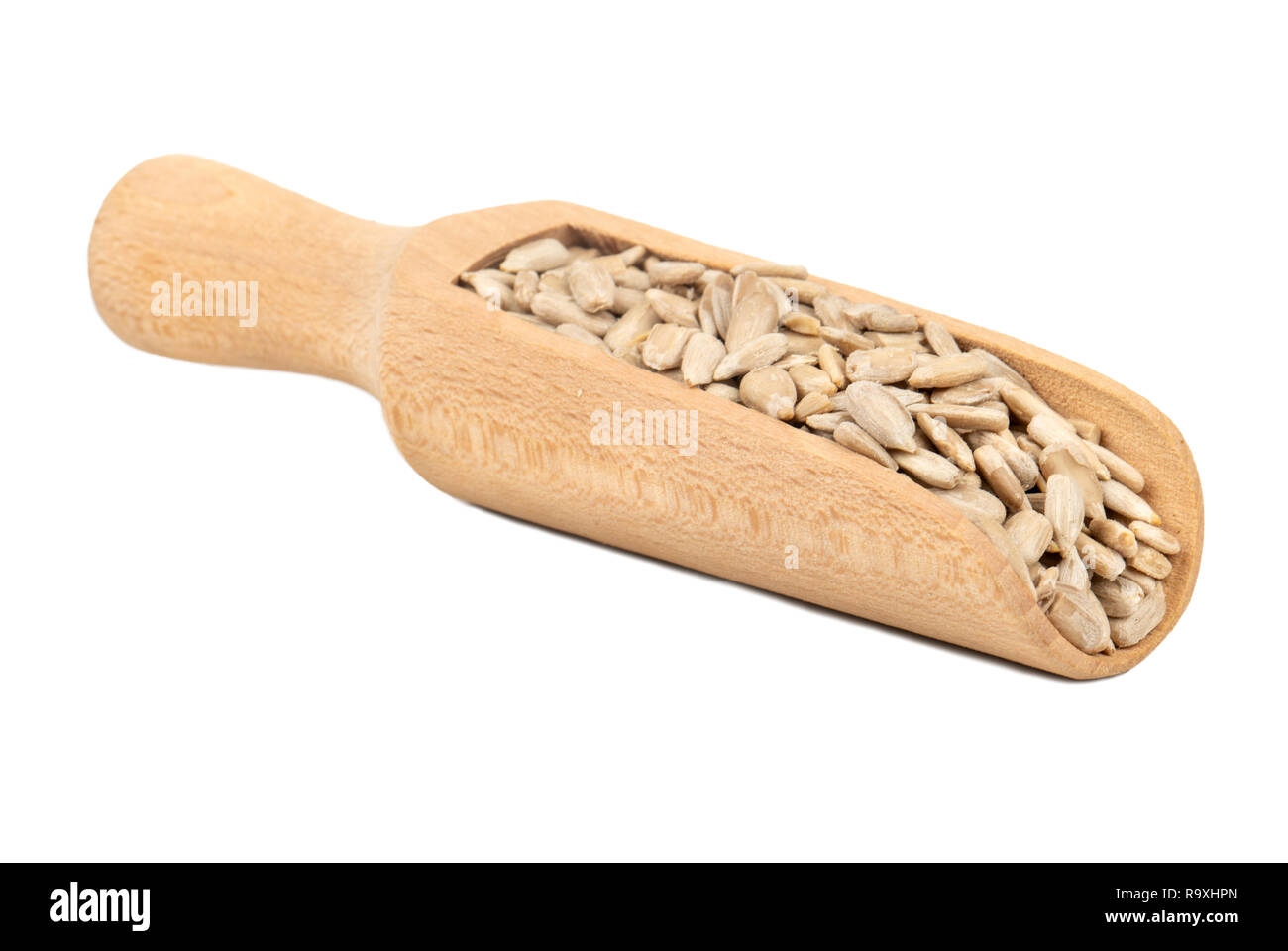 Sunflower seeds without shell in a wooden scoop on a white background ...