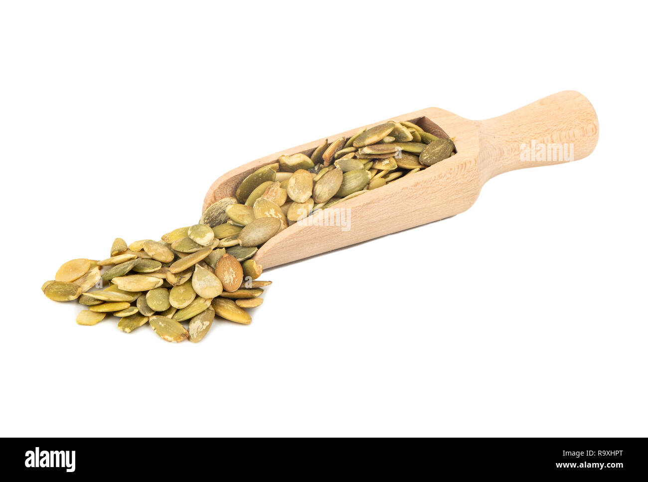 Pumpkin seeds without shell in scoop on white background Stock Photo ...