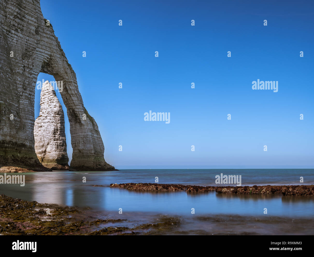 Chalk cliffs of Etretat (Normandy France) with the natural arch Porte d ...