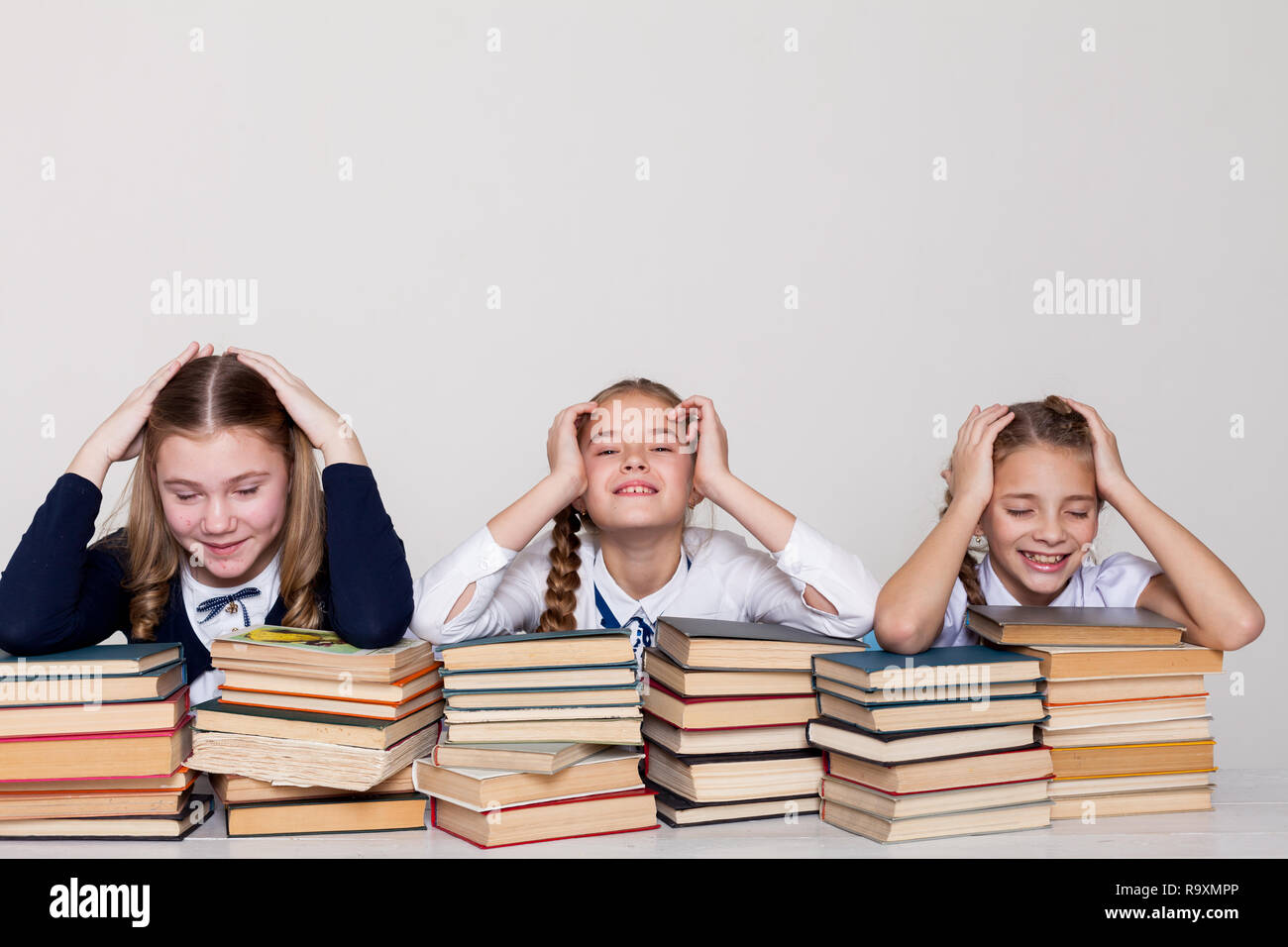 three girls at school in the classroom for books knowledge Stock Photo ...