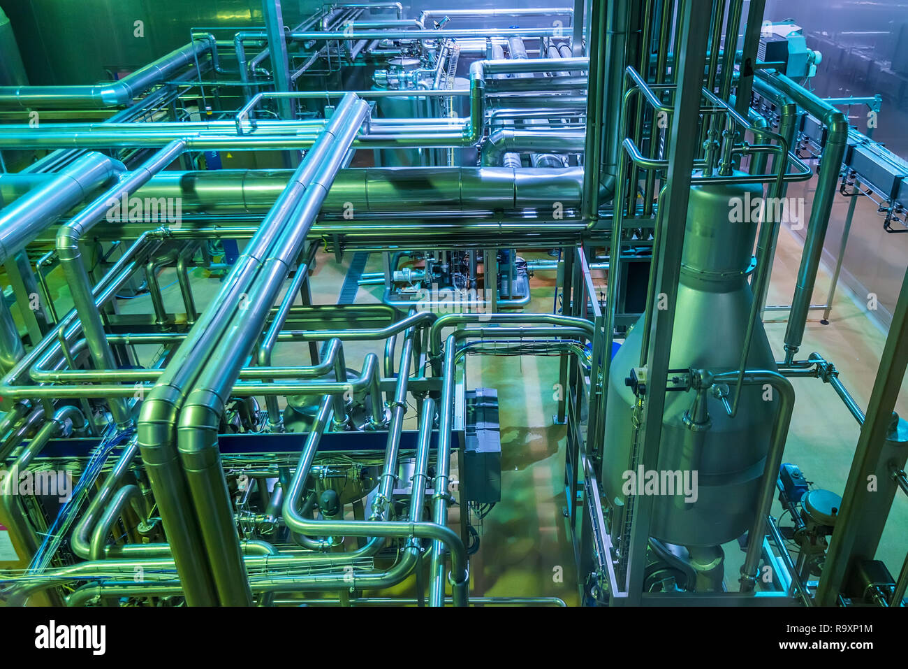 View of tubes and appliances at soft drinks factory Stock Photo - Alamy