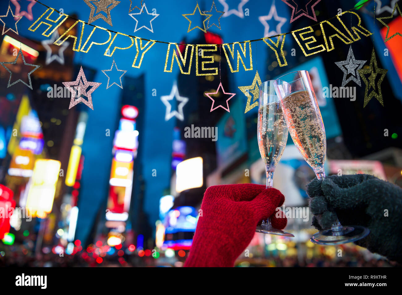 Happy New Year message hanging over gloved hands making a celebration ...