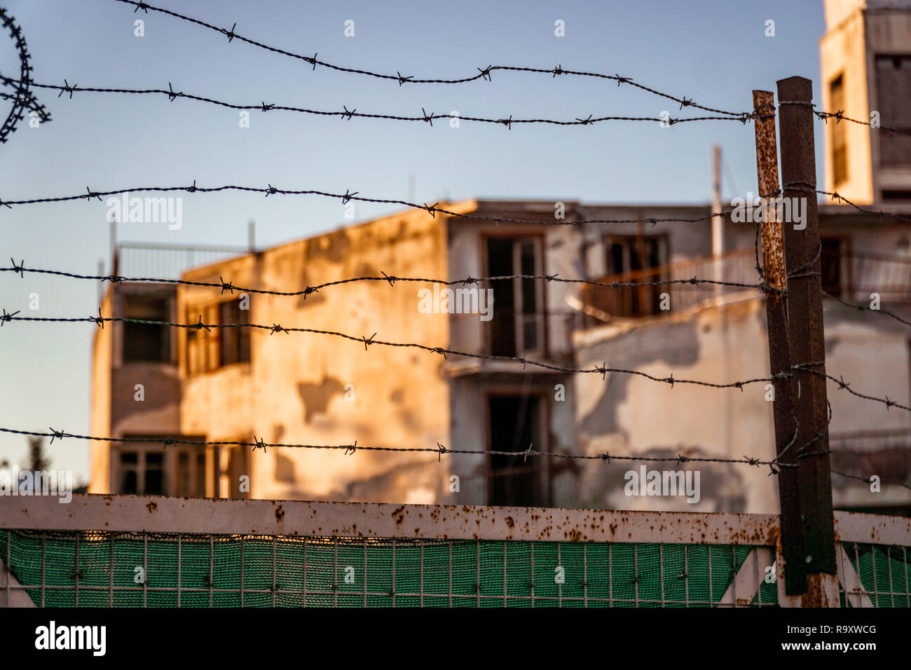 Old rusty barbed wire fence in the UN buffer zone marking the border ...