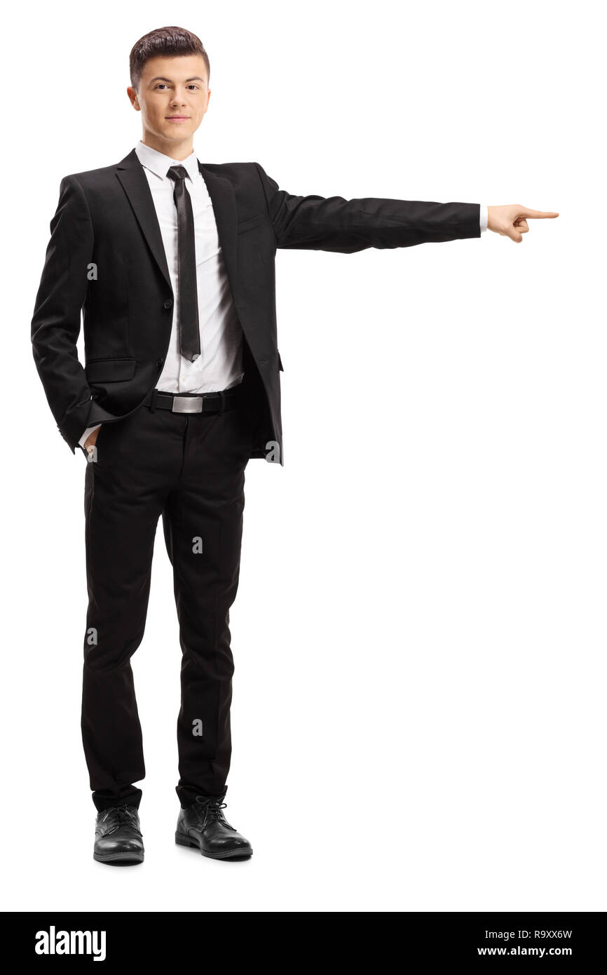 Full length portrait of a young male adult in an elegant suit pointing ...
