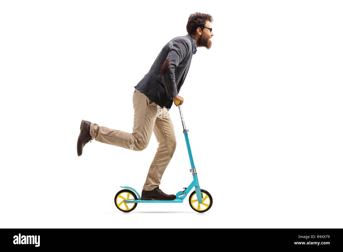 Full length profile shot of a bearded man riding a scooter isolated on ...