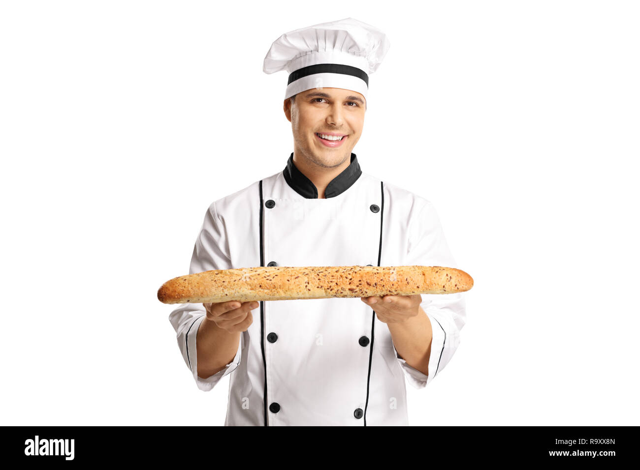 Young male baker holding a freshly baked baguette bread isolated on ...