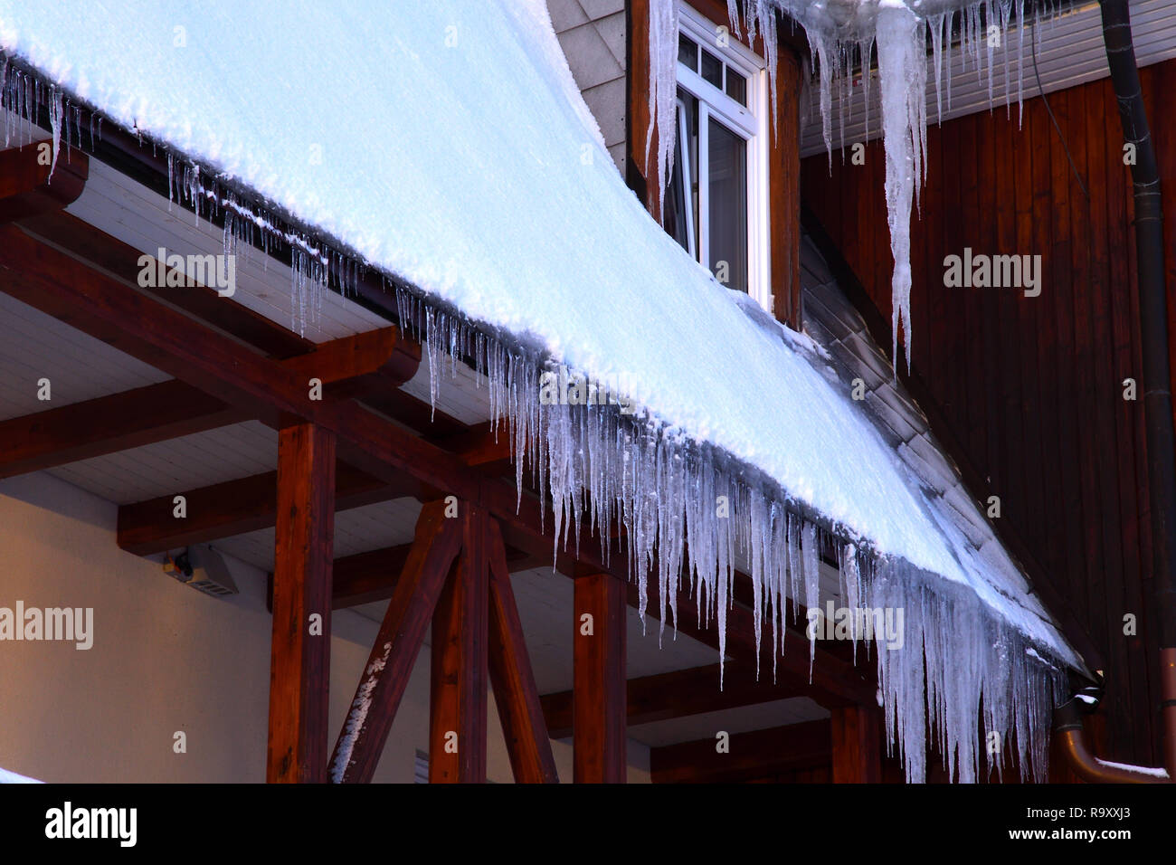 freezing cold and icicles hanging down on home window Stock Photo - Alamy
