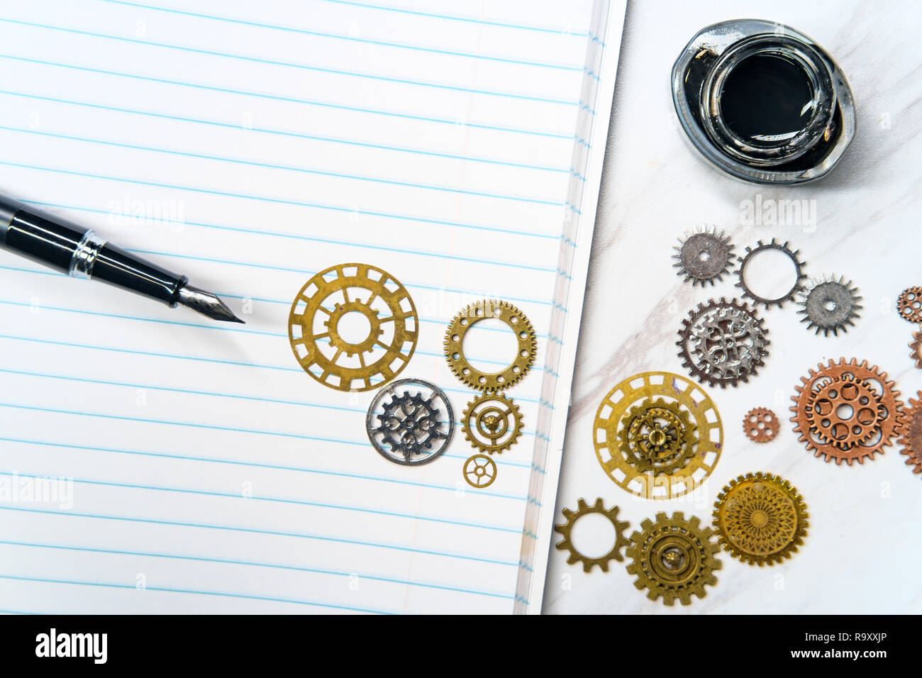 Retro pen and ink with lined notebook and gears for creative writing ...