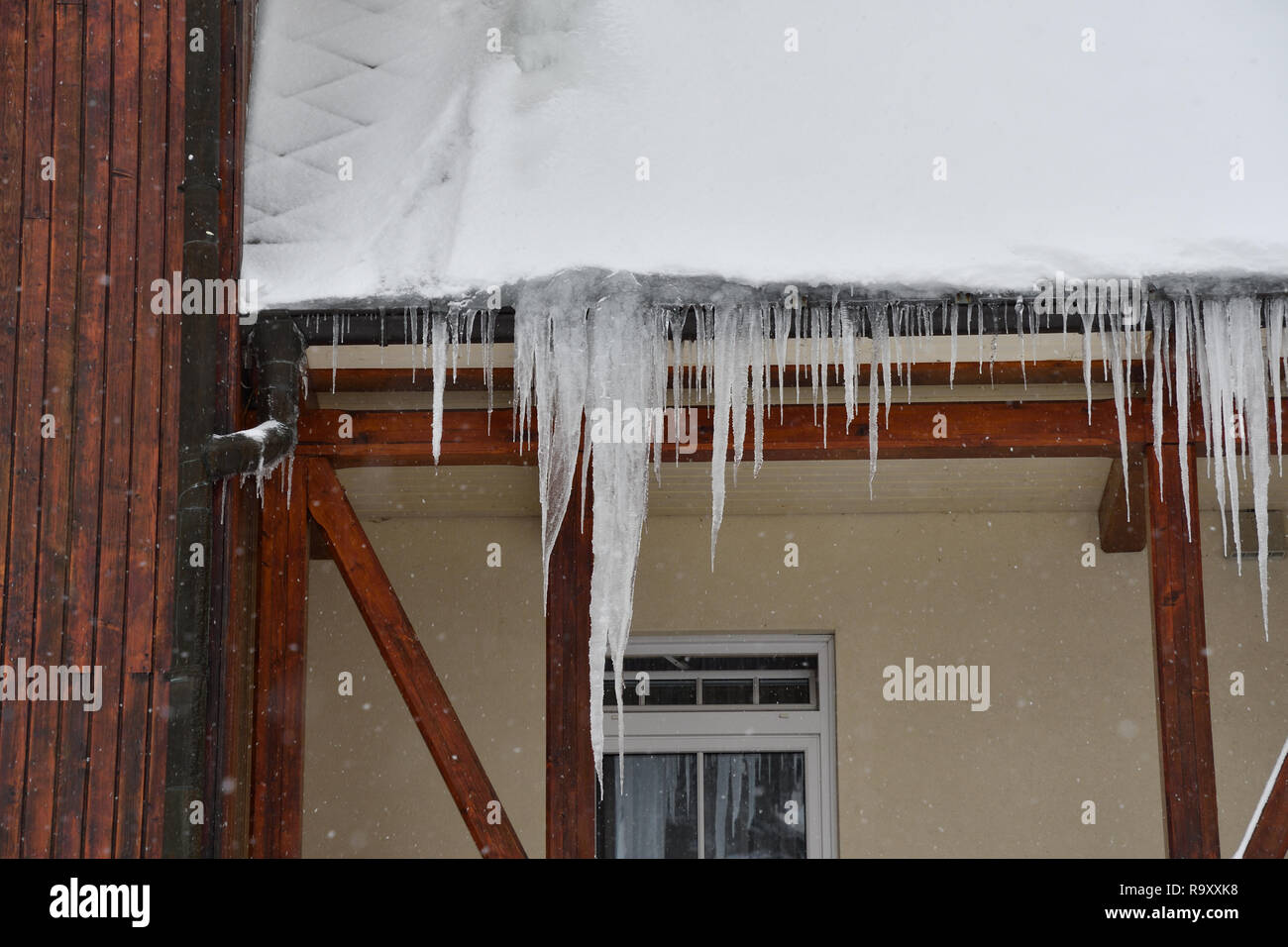 freezing cold and icicles hanging down on home window Stock Photo - Alamy