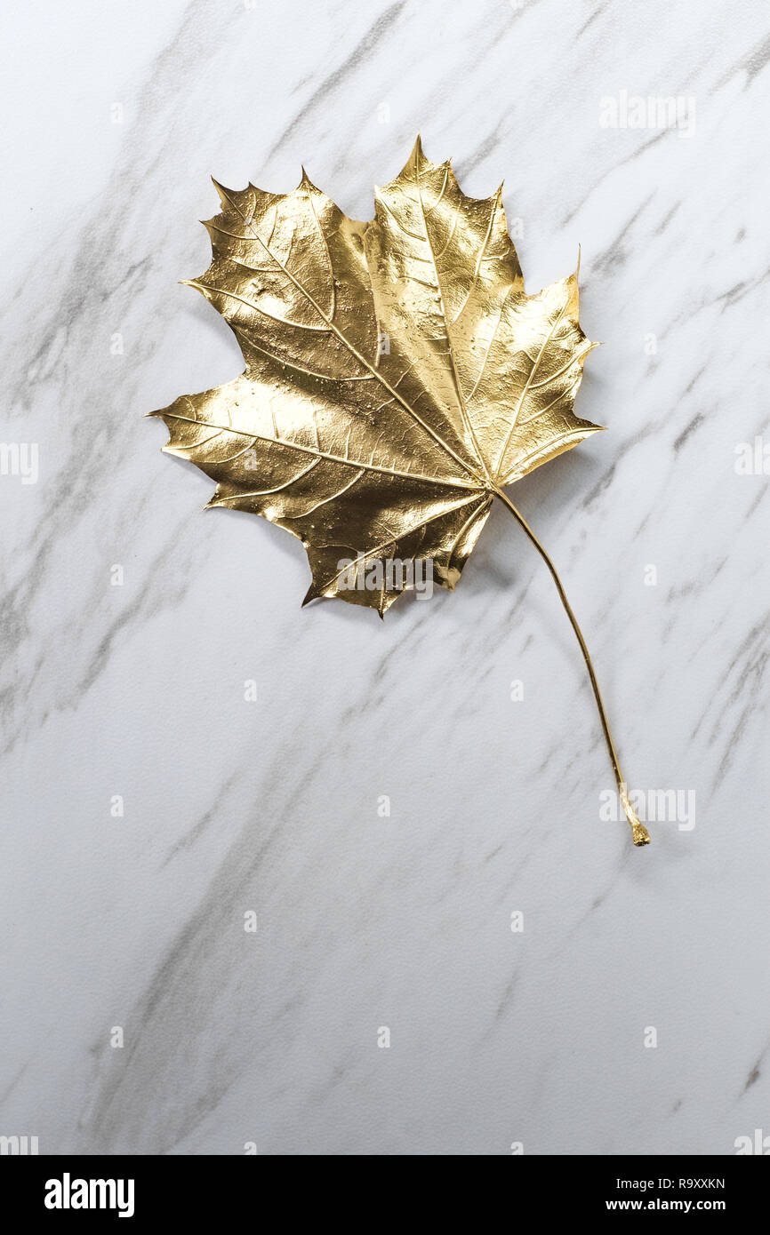 Golden Christmas maple leaf on marble table in closeup Stock Photo - Alamy