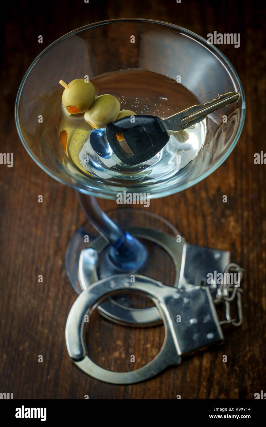 Gin martini with handcuffs and keys symbolizing drunk driving arrest ...