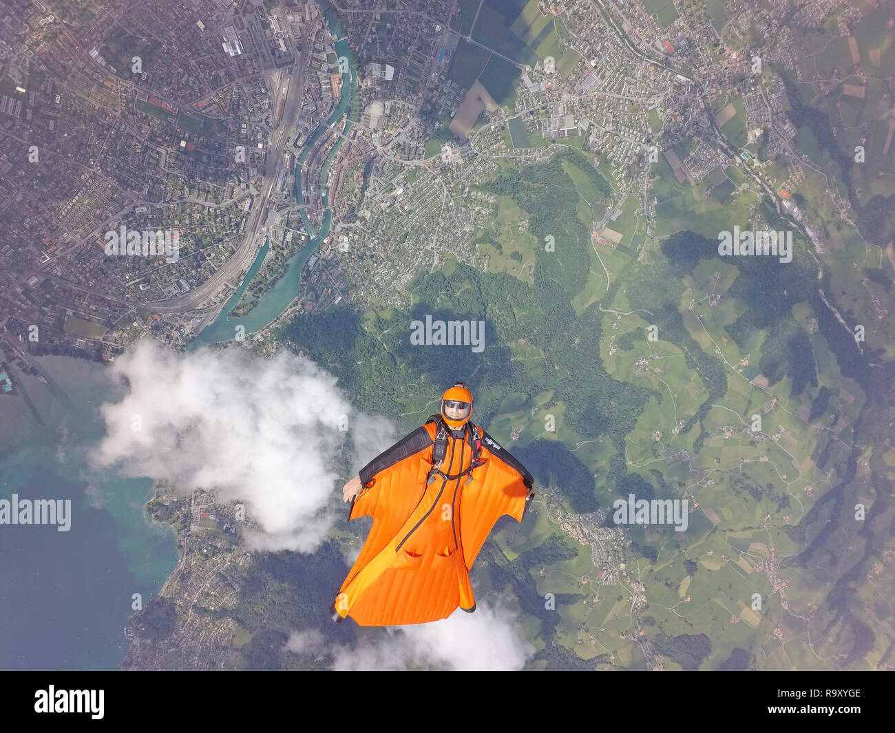 This wingsuit pilot is flying free in the sky and is soaring for a long ...
