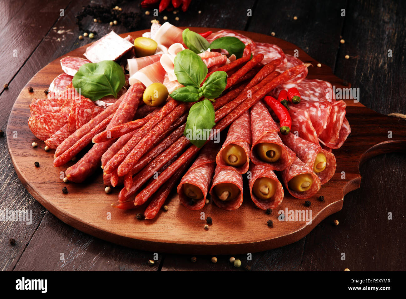Food tray with delicious salami, pieces of sliced prosciutto crudo ...