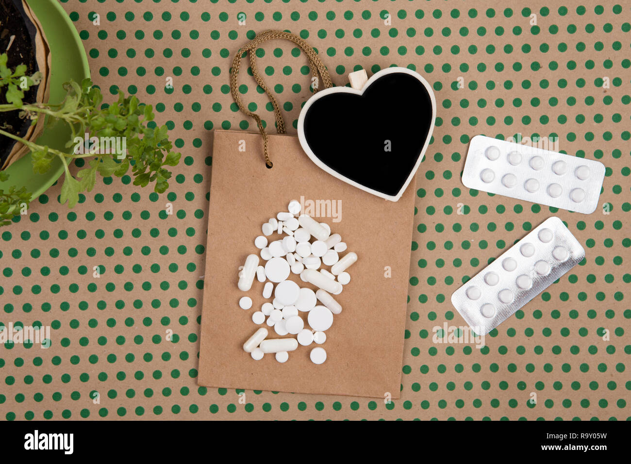 Medical concept - white pills and capsules, handmade shopping bag, gift ...