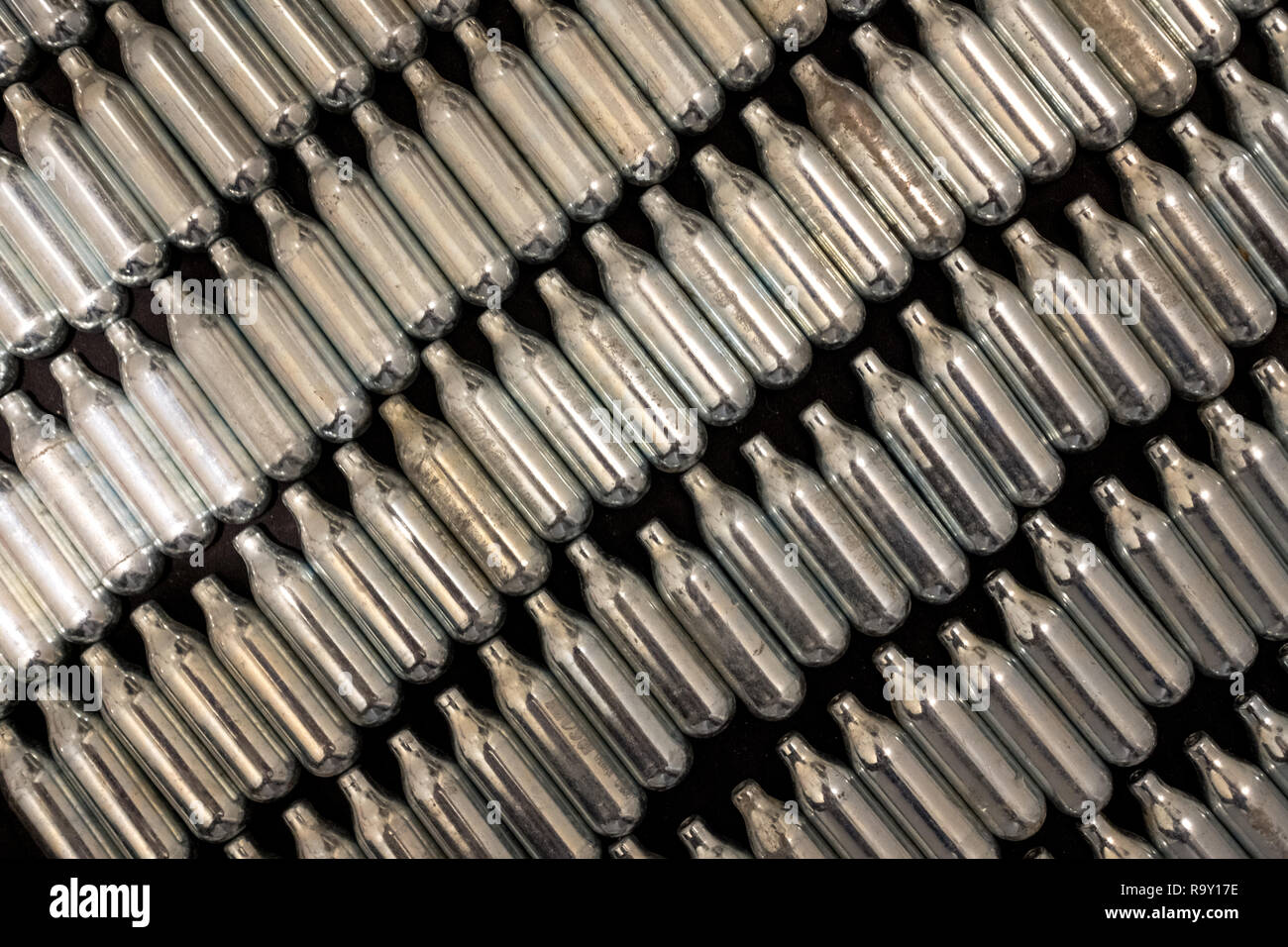 Rows of old rusty nitrous oxide cannisters / cream puff chargers: the ...