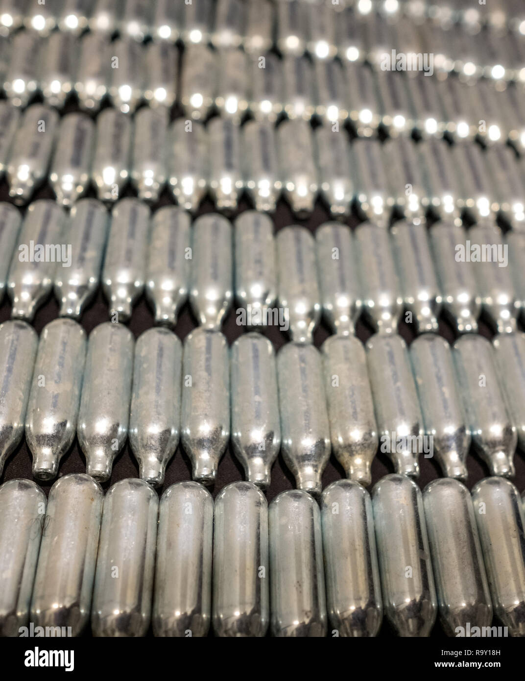 Rows of old rusty nitrous oxide cannisters / cream puff chargers: the ...