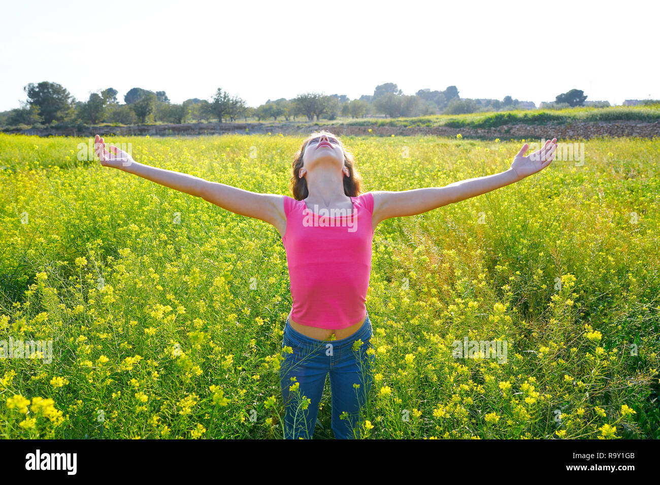 open arms happy teen girl in spring meadow brunette Stock Photo - Alamy