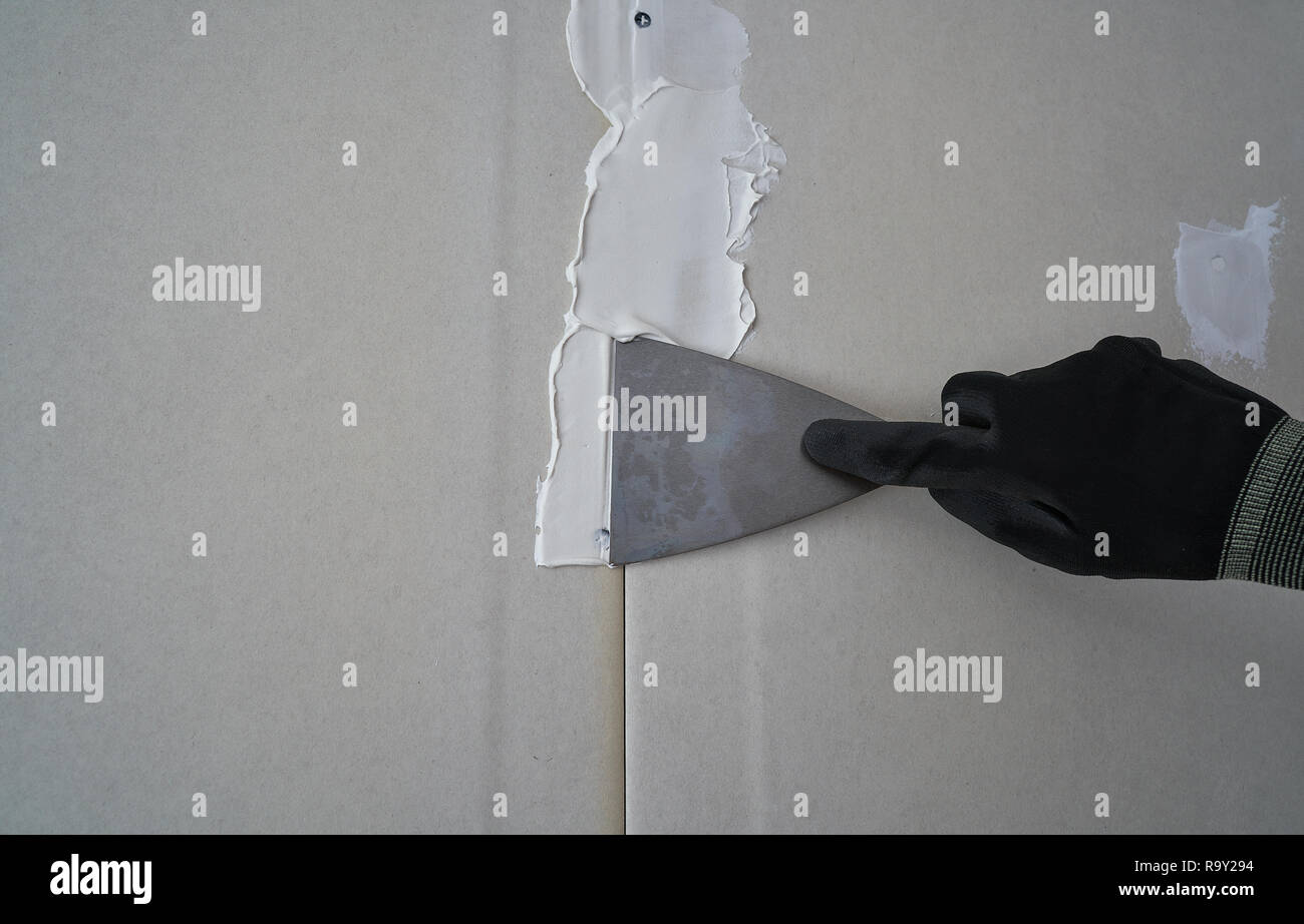 laminated plasterboard plastering join detail spatula and hand Stock ...