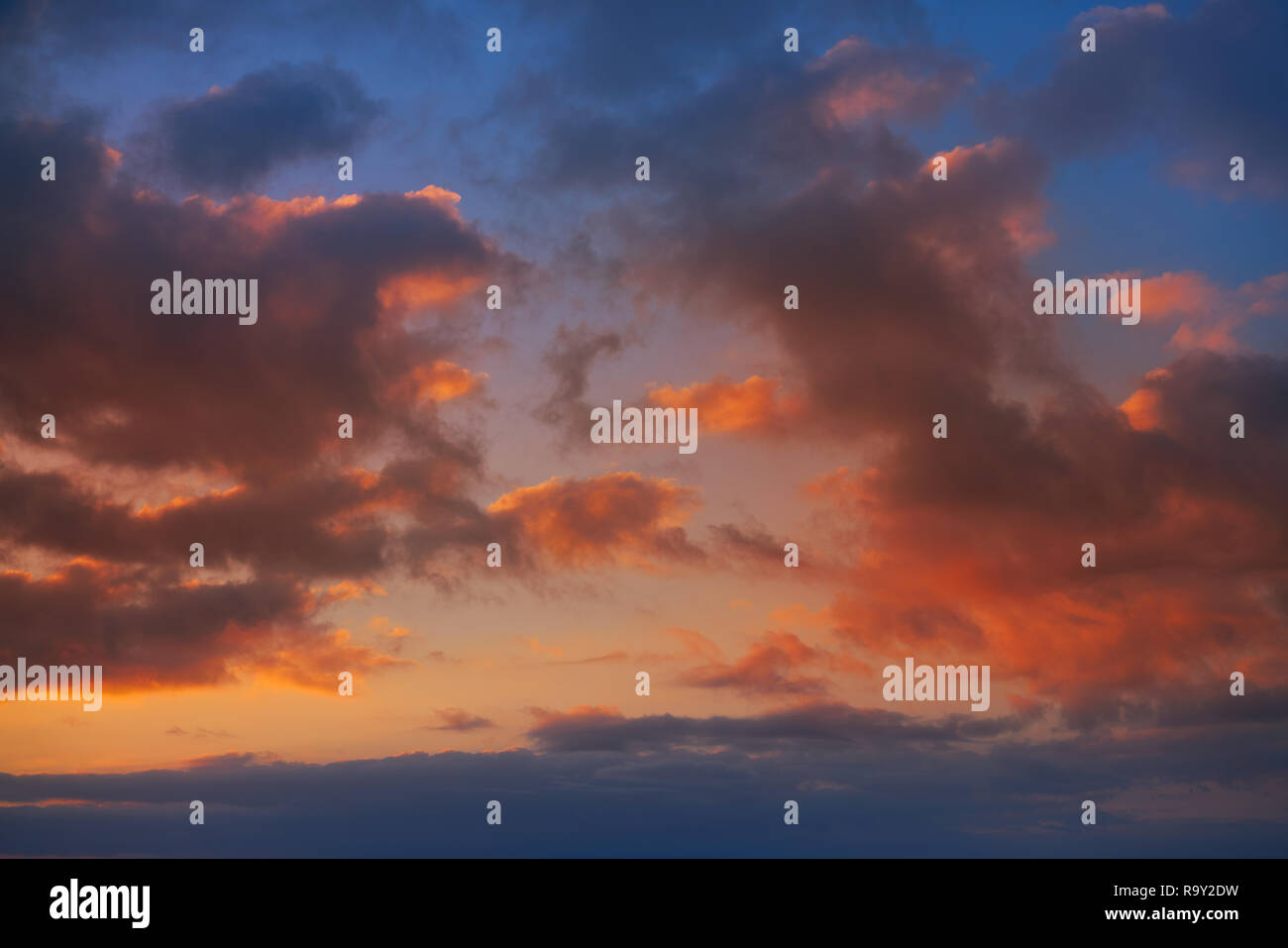 Sunset sky clouds orange and blue colors Stock Photo - Alamy