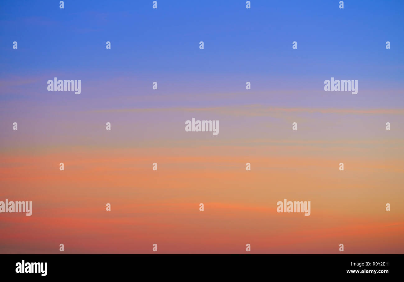 Sunset sky clouds orange and blue colors Stock Photo - Alamy