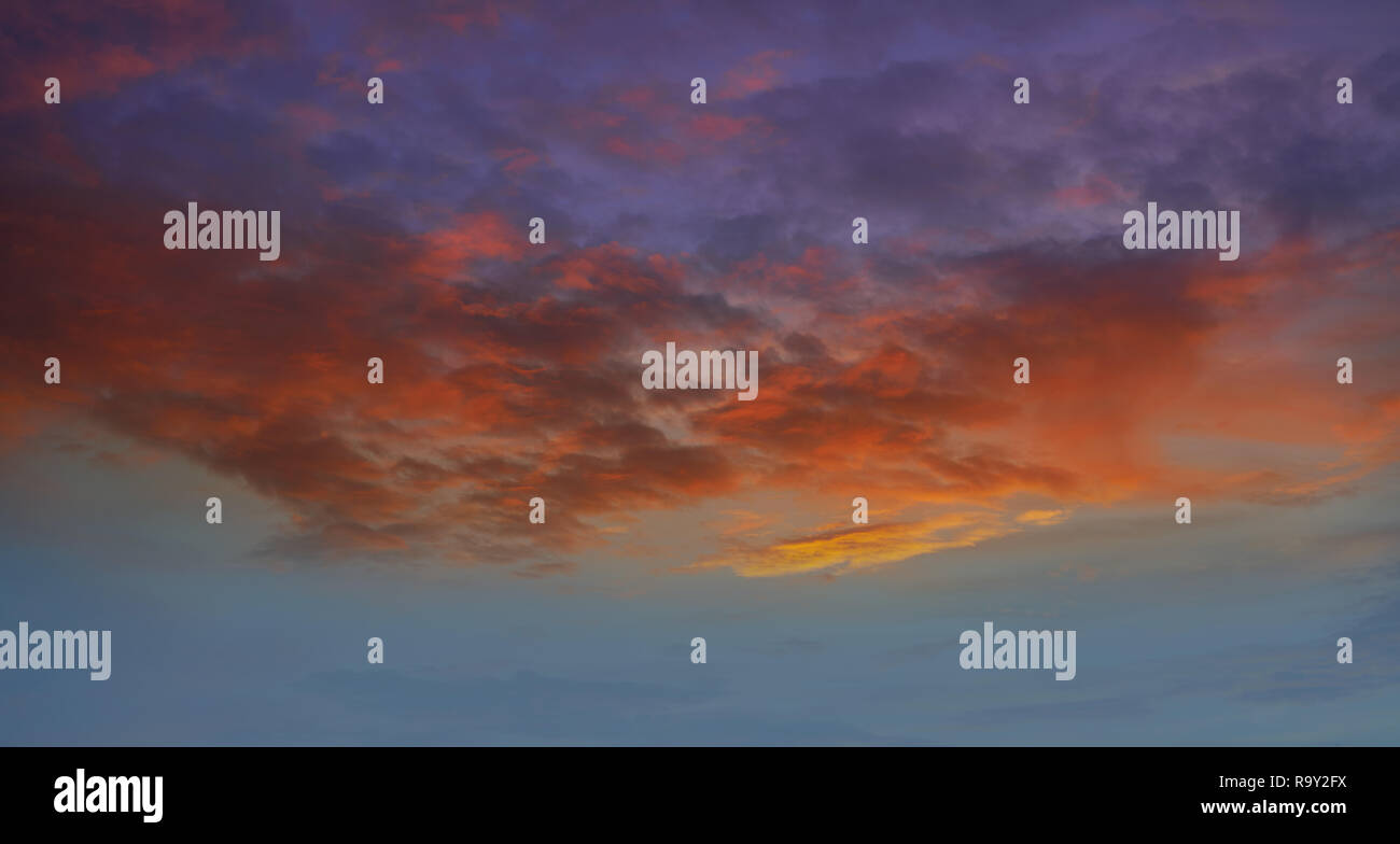 Sunset sky clouds orange and blue colors Stock Photo - Alamy