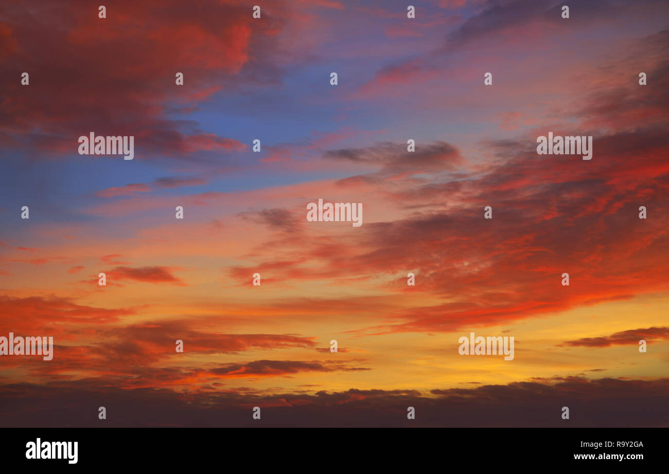 Sunset sky clouds orange and blue colors Stock Photo - Alamy