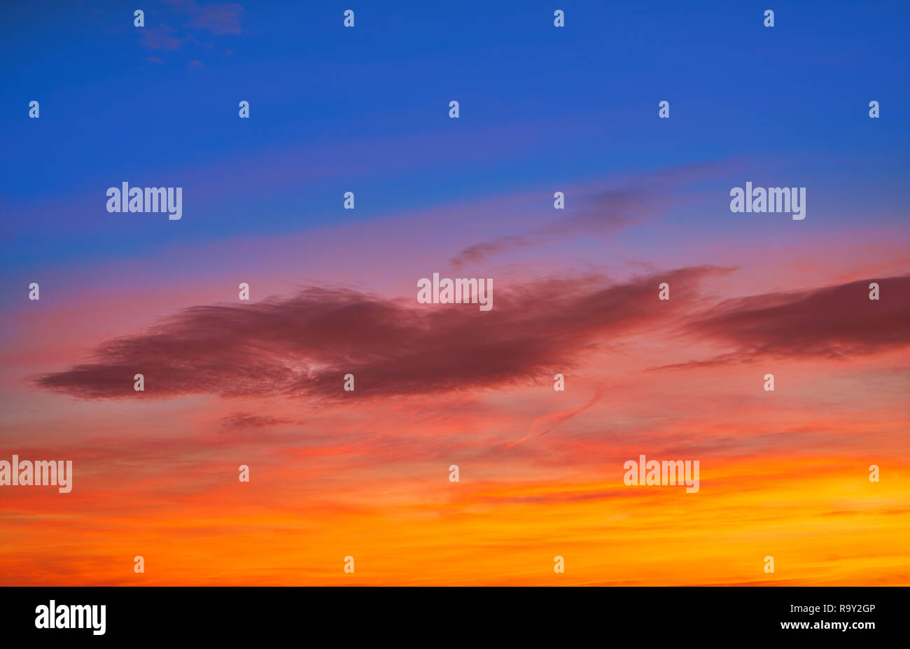 Sunset sky clouds orange and blue colors Stock Photo - Alamy