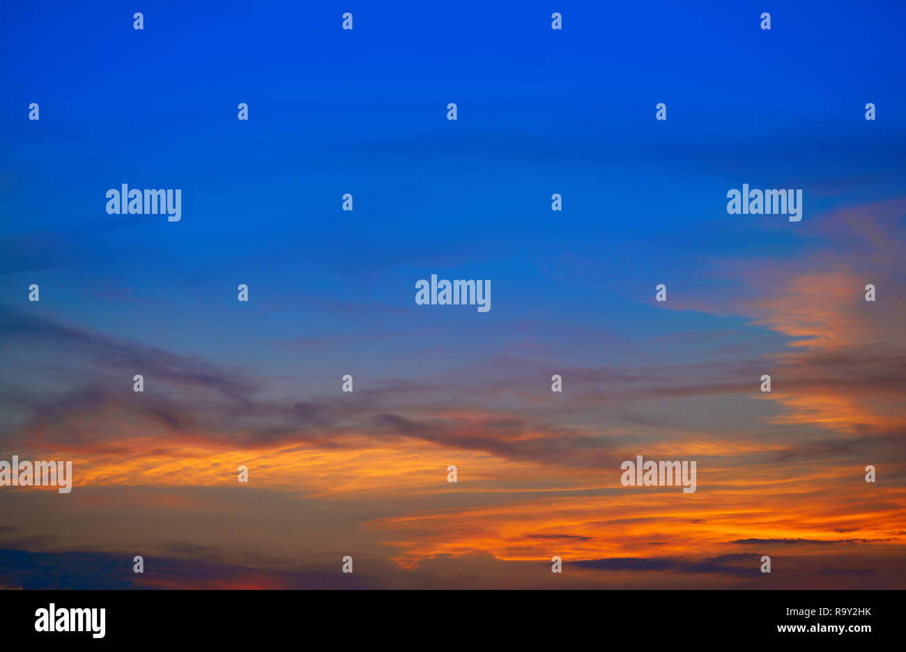 Sunset sky clouds orange and blue colors Stock Photo - Alamy