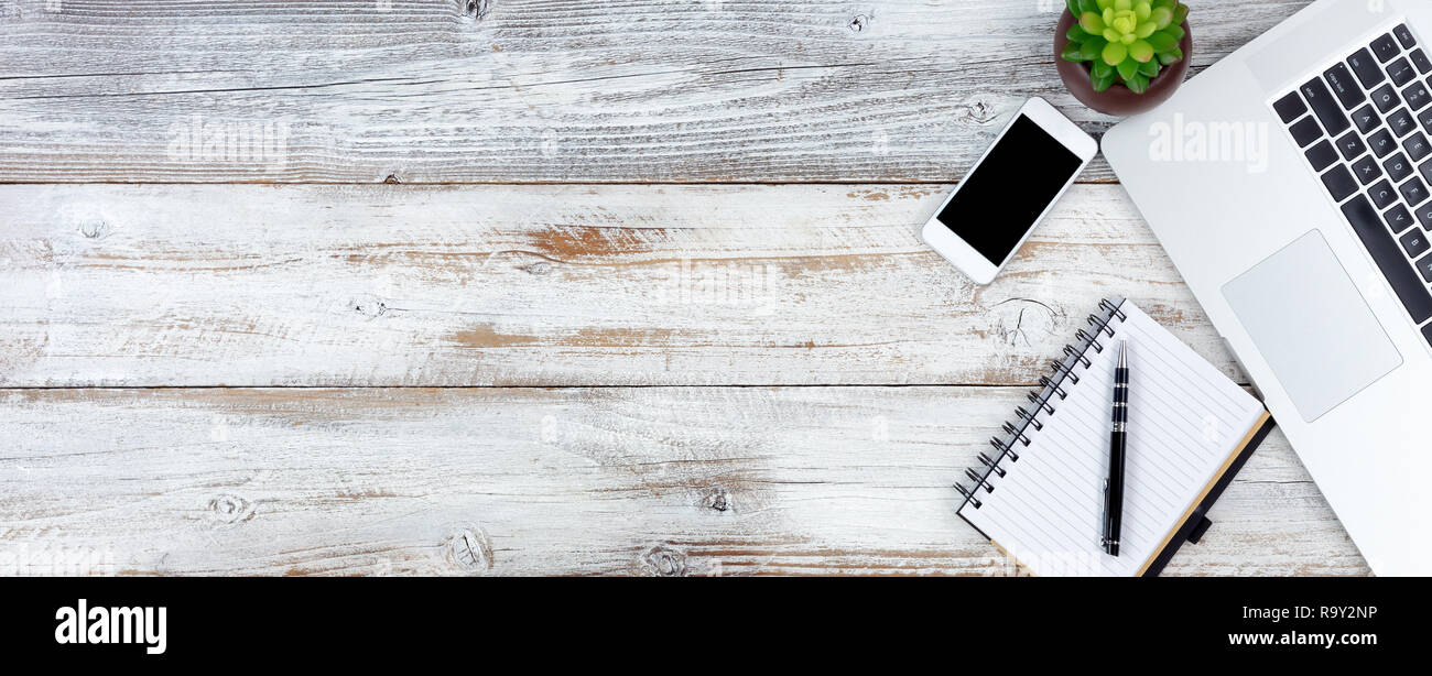 Top view of white rustic desk with laptop computer and working items ...