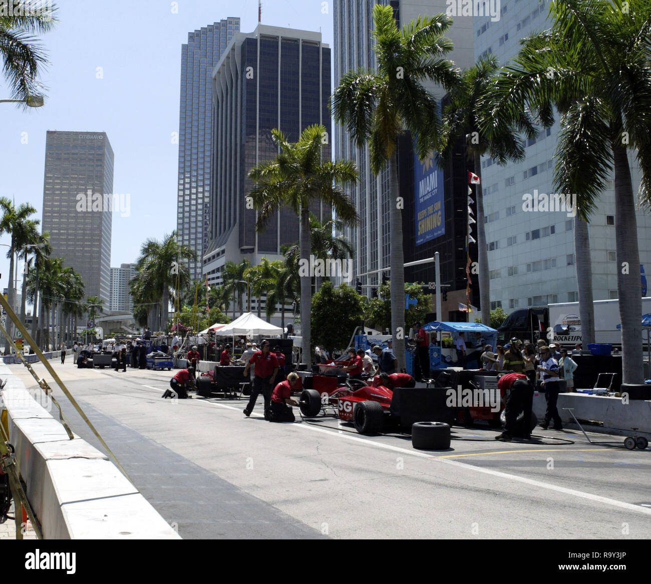 Pit crews work on their cars during a practice round for the CART Grand ...