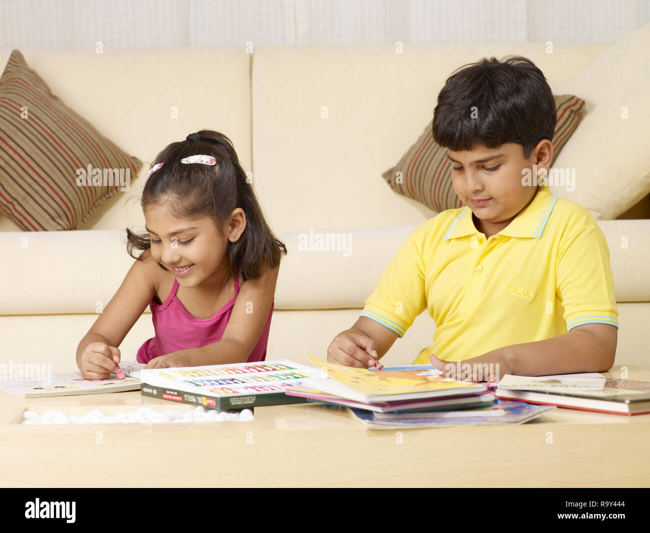 YOUNG BOY AND GIRL DRAWING AND STUDYING IN THEIR HOME Stock Photo - Alamy