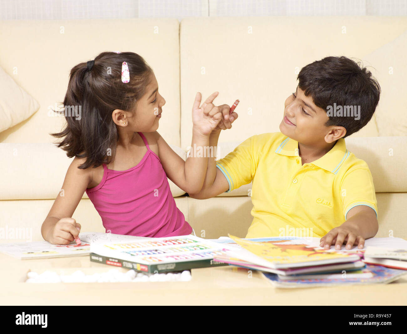 YOUNG BOY AND GIRL DRAWING AND STUDYING IN THEIR HOME Stock Photo - Alamy
