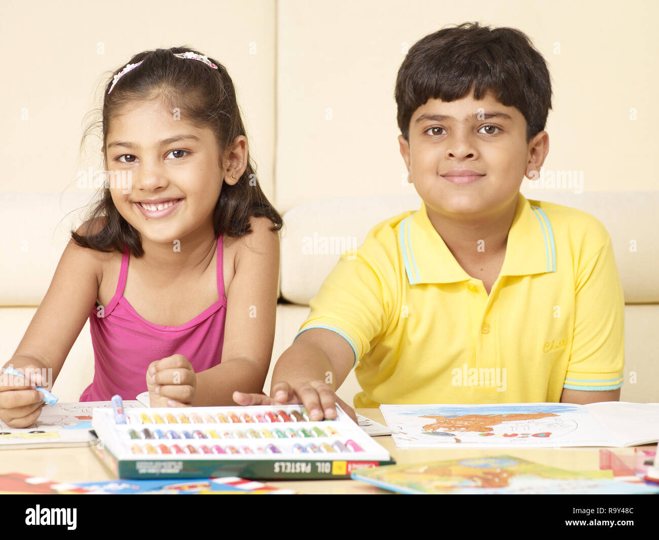 YOUNG BOY AND GIRL DRAWING AND STUDYING IN THEIR HOME Stock Photo - Alamy