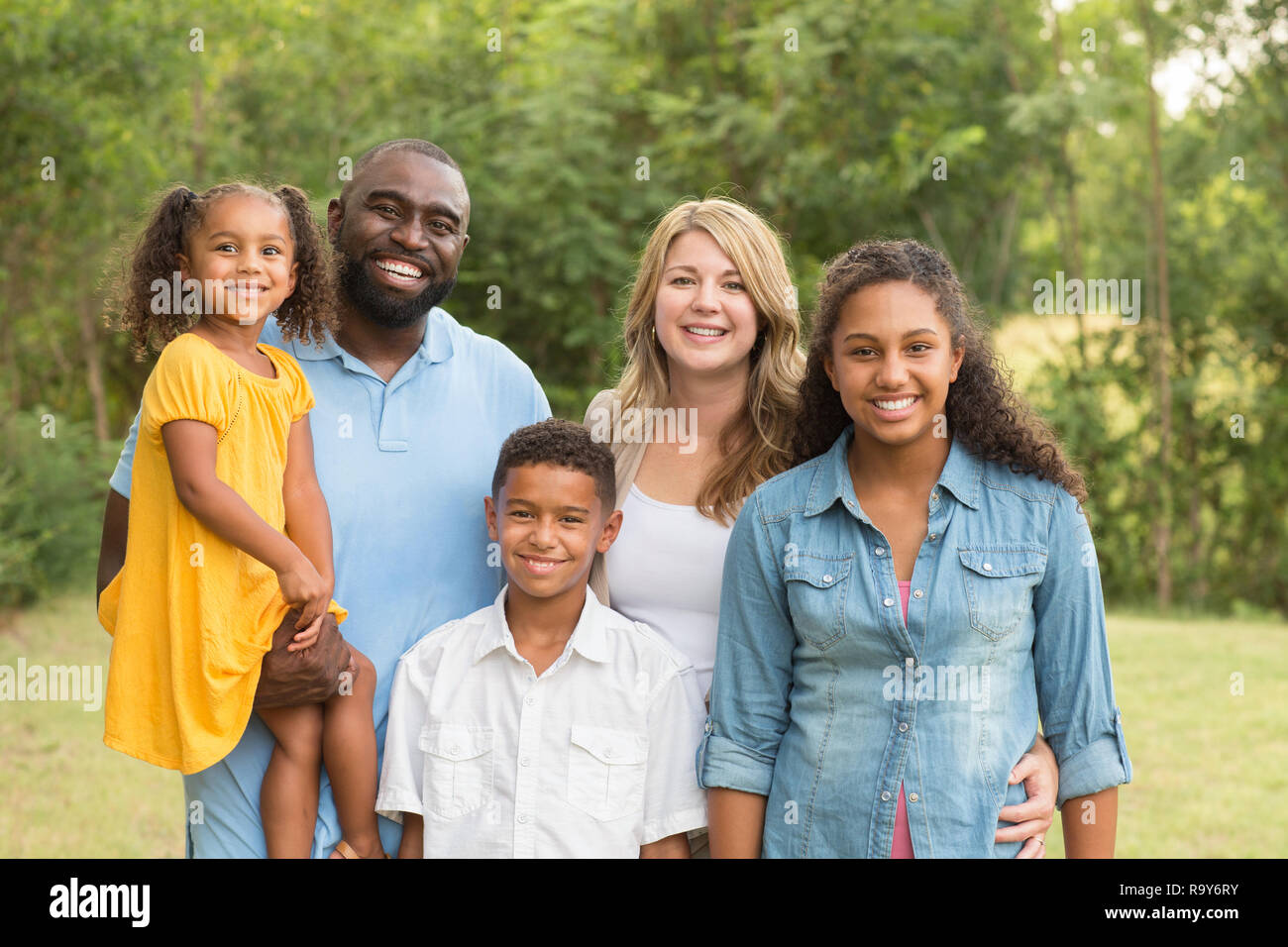 Portrait of a multi ethnic family laughing Stock Photo - Alamy