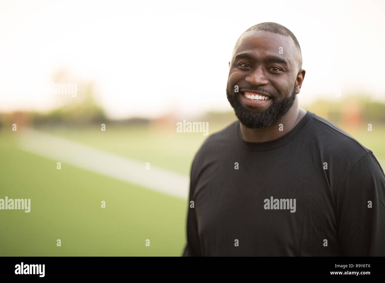 Portrait of an African American Football coach smiling Stock Photo - Alamy