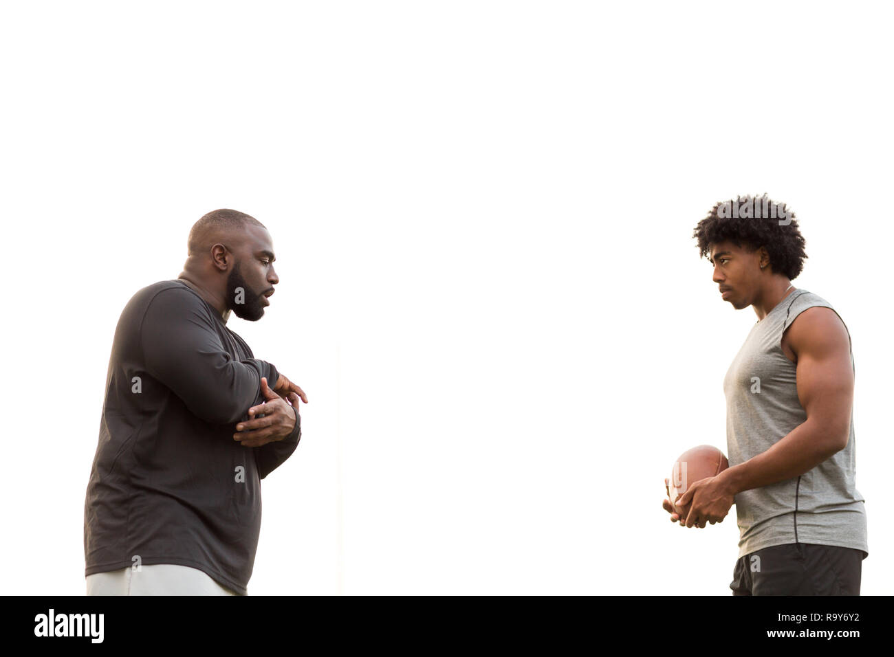 American Football coach training a young athlete Stock Photo - Alamy