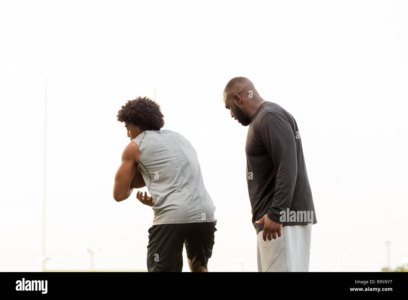 American Football coach training a young athlete Stock Photo - Alamy