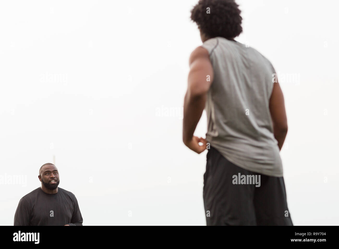 American Football coach training a young athlete Stock Photo - Alamy
