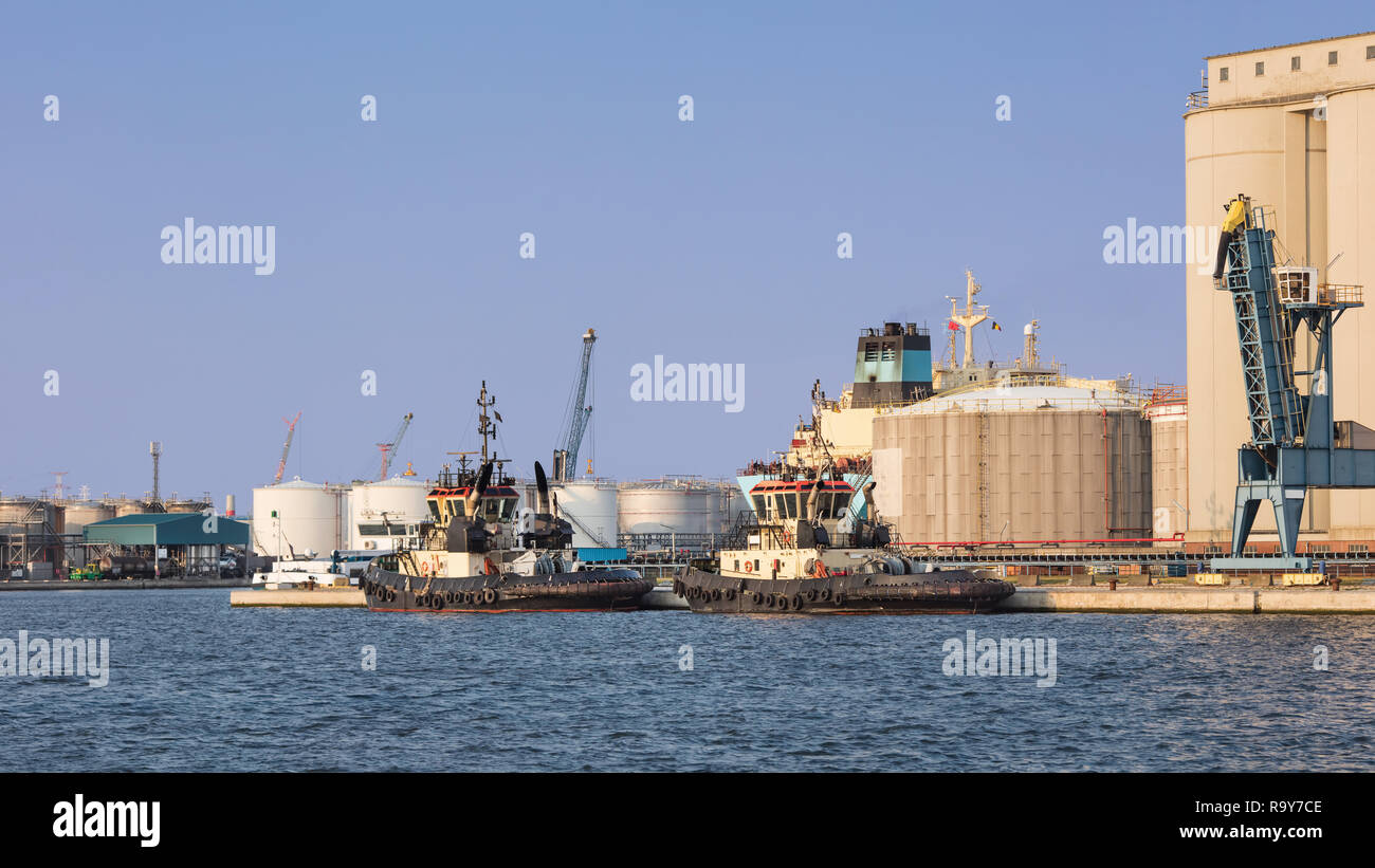 Tugs moored at an oil refinery, Port of Antwerp, Belgium Stock Photo ...