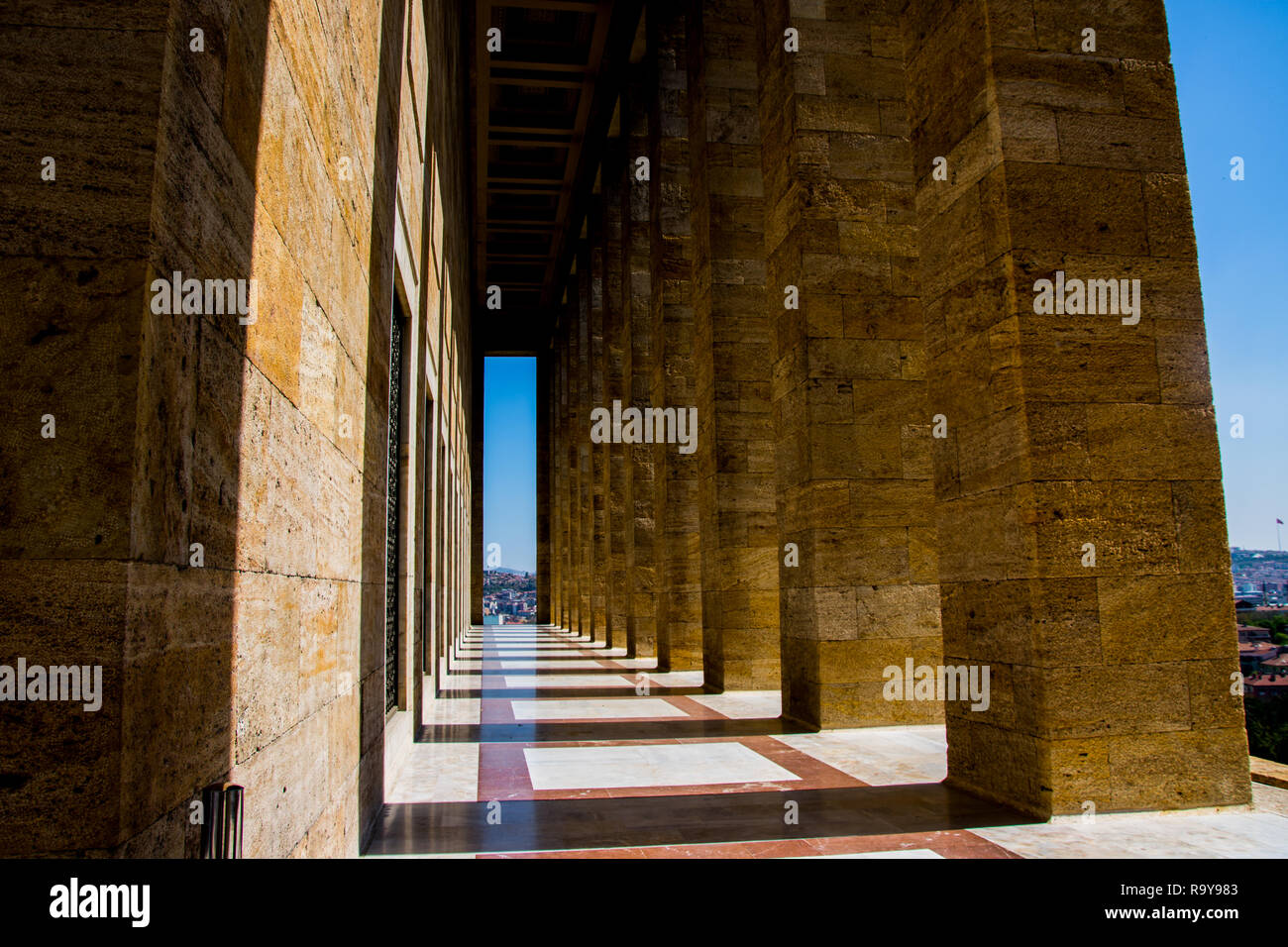 The narrow passage with the pattern columns making shadows around the ...