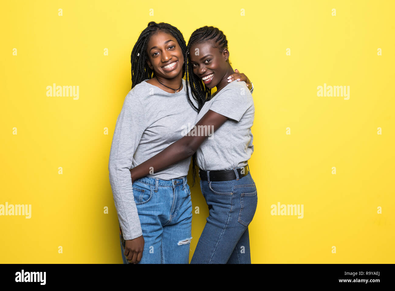 Photo of lovely african womens stand closely hug each other embrace ...