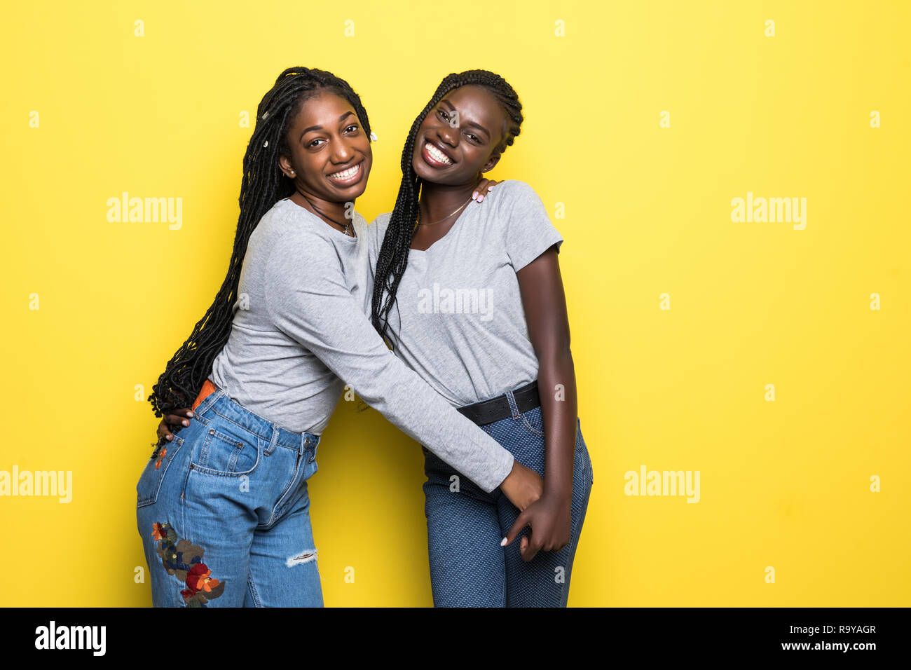 Photo of lovely african womens stand closely hug each other embrace ...