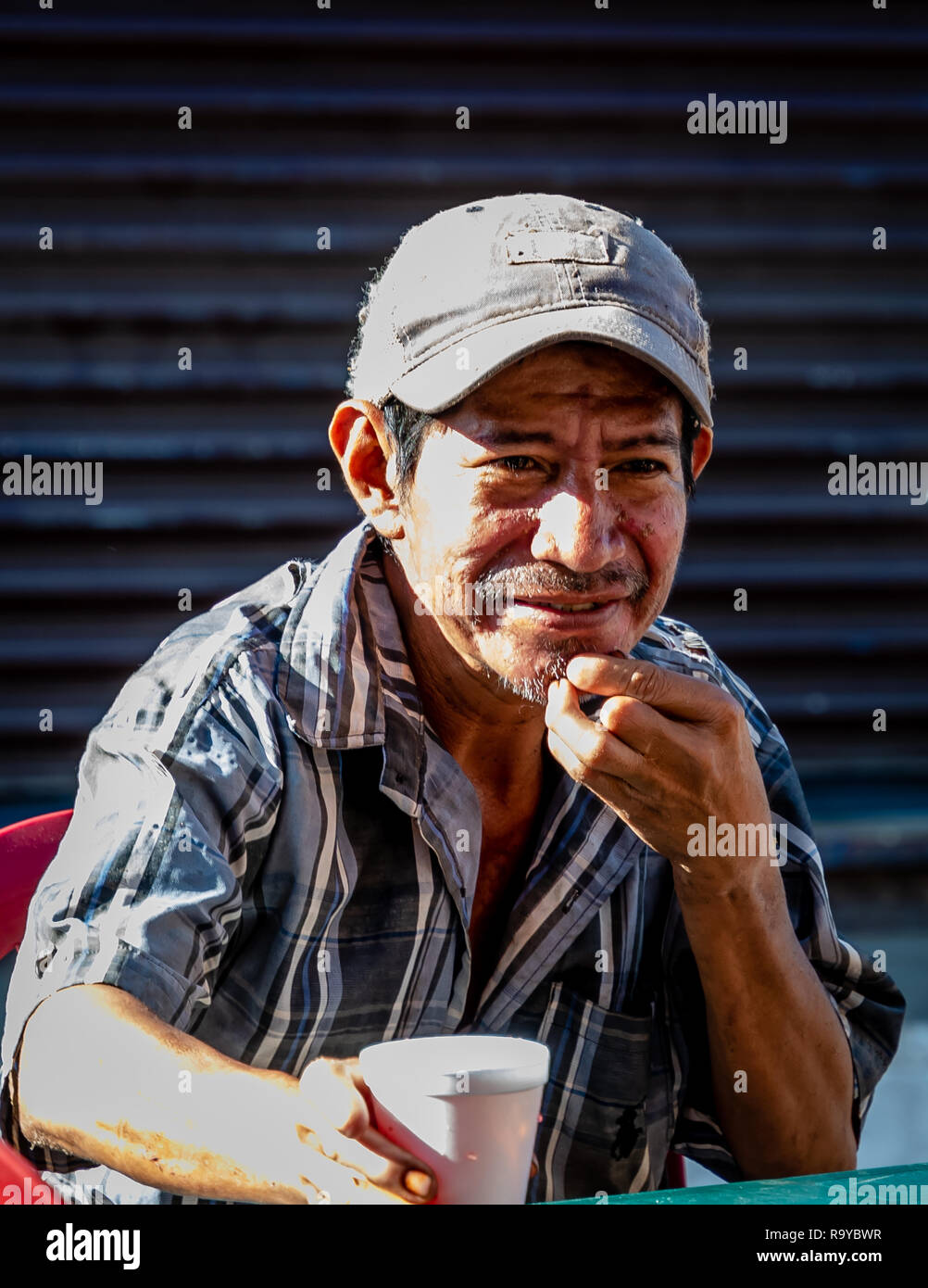 homeless man eating food on street in Guatemala Stock Photo - Alamy