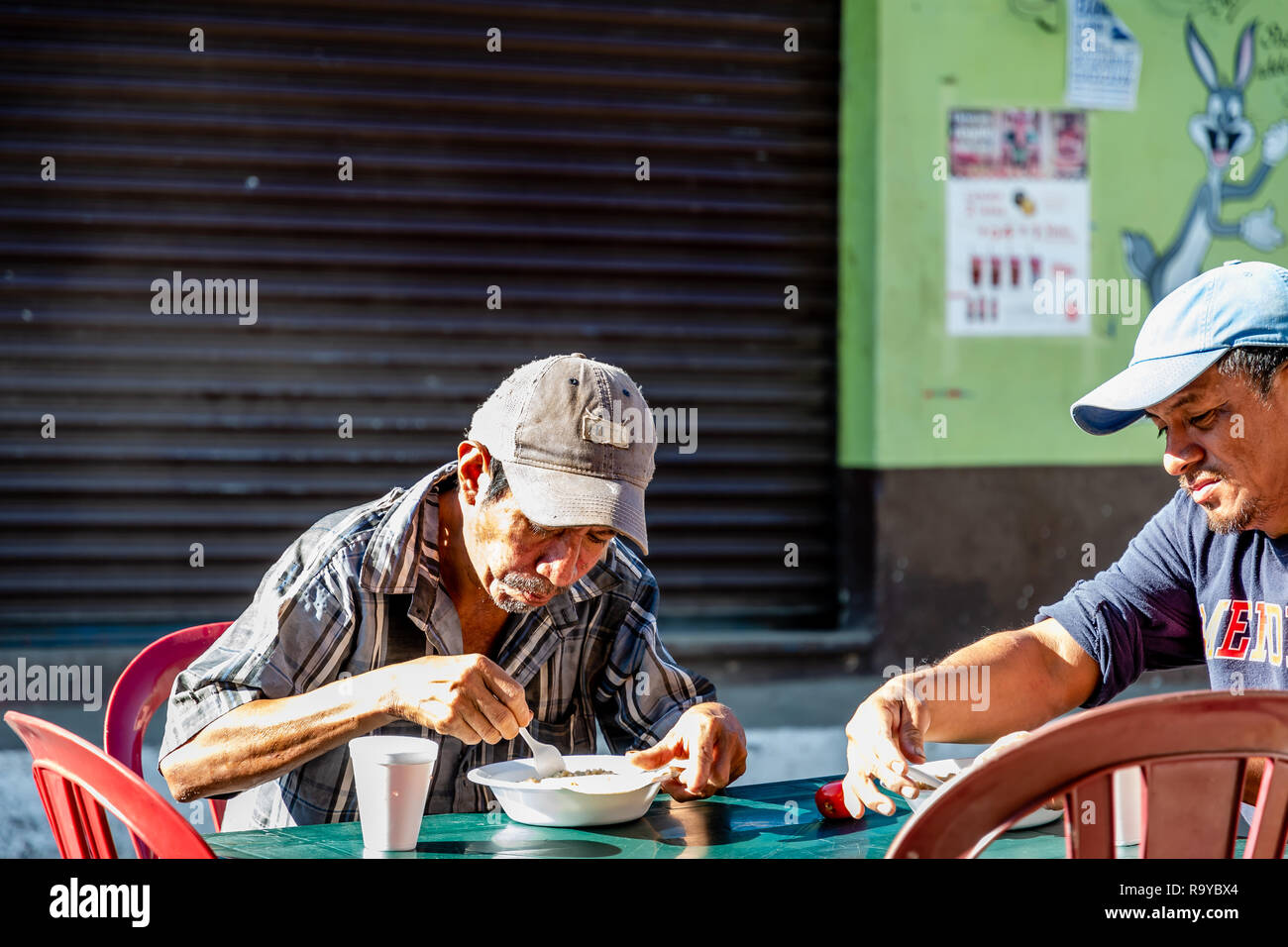 Homeless man eating food hi-res stock photography and images - Alamy