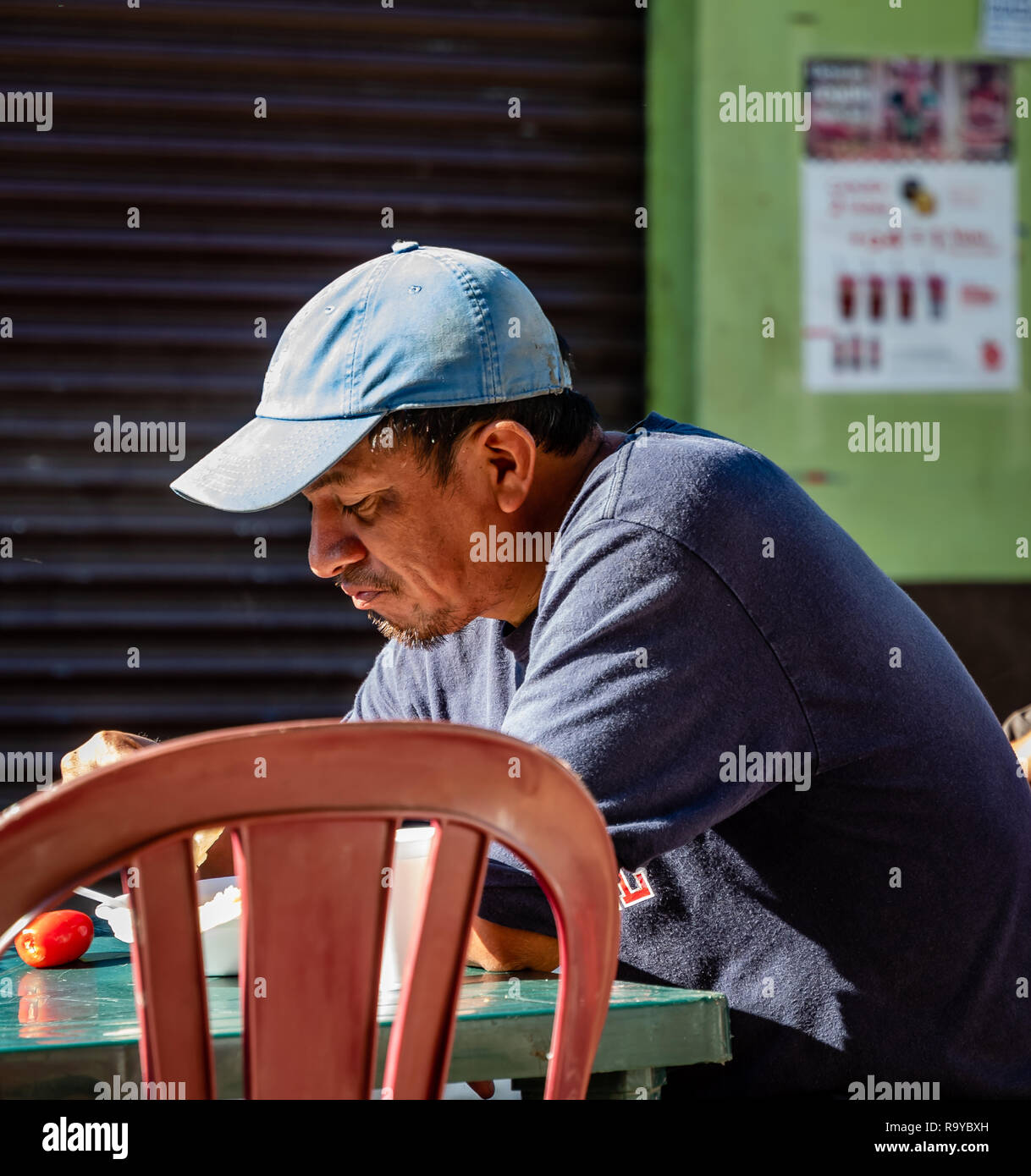 homeless man eating food on street in Guatemala Stock Photo - Alamy