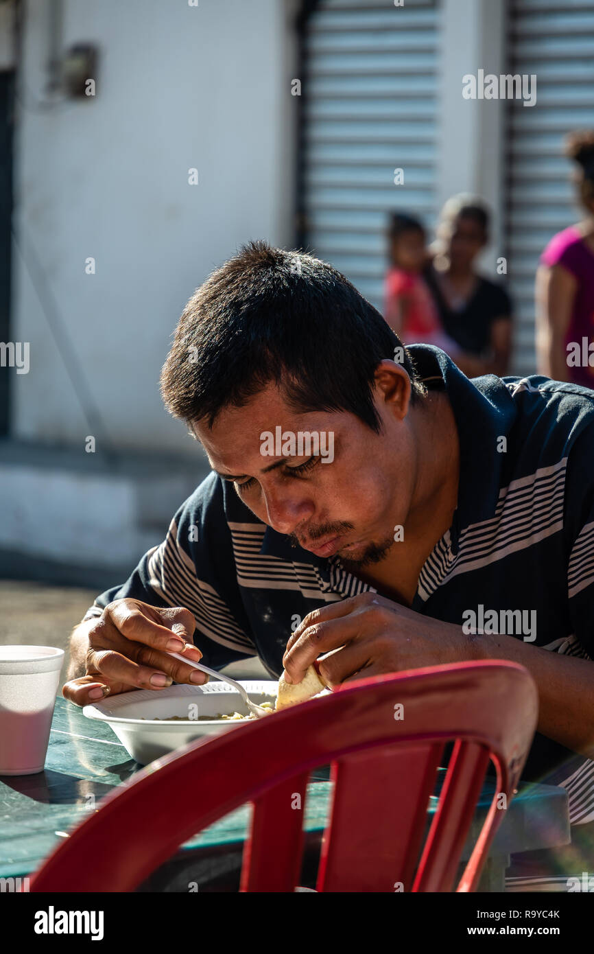 homeless man eating food on street in Guatemala Stock Photo - Alamy