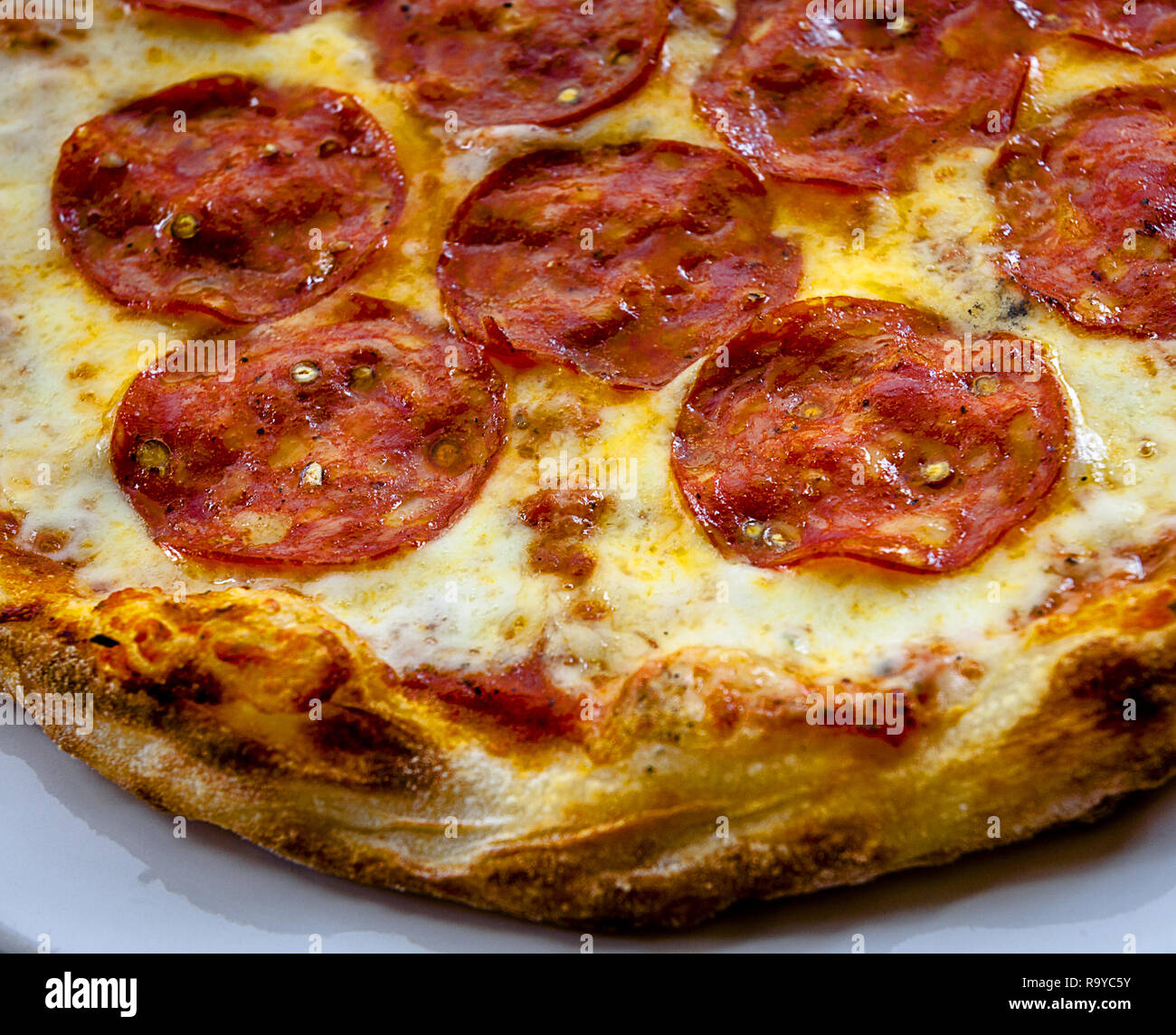 Close up of Pepperoni Pizza unsliced, showing nice crust Stock Photo ...